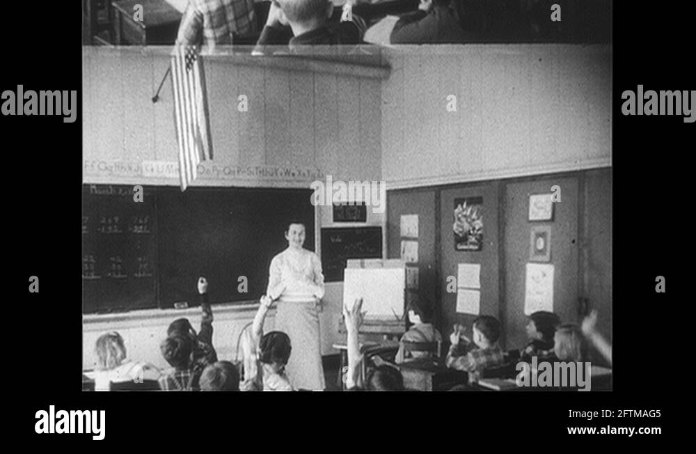1950s: Teacher and students in classroom, students raise hands / United ...