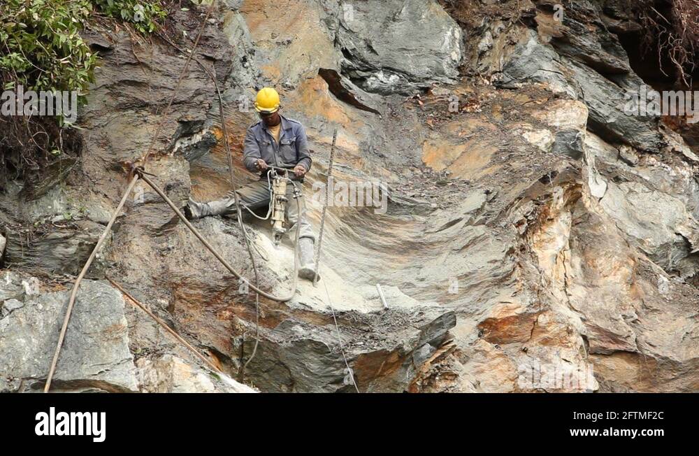 Drilling holes in a cliff face for blasting Stock Video Footage - Alamy
