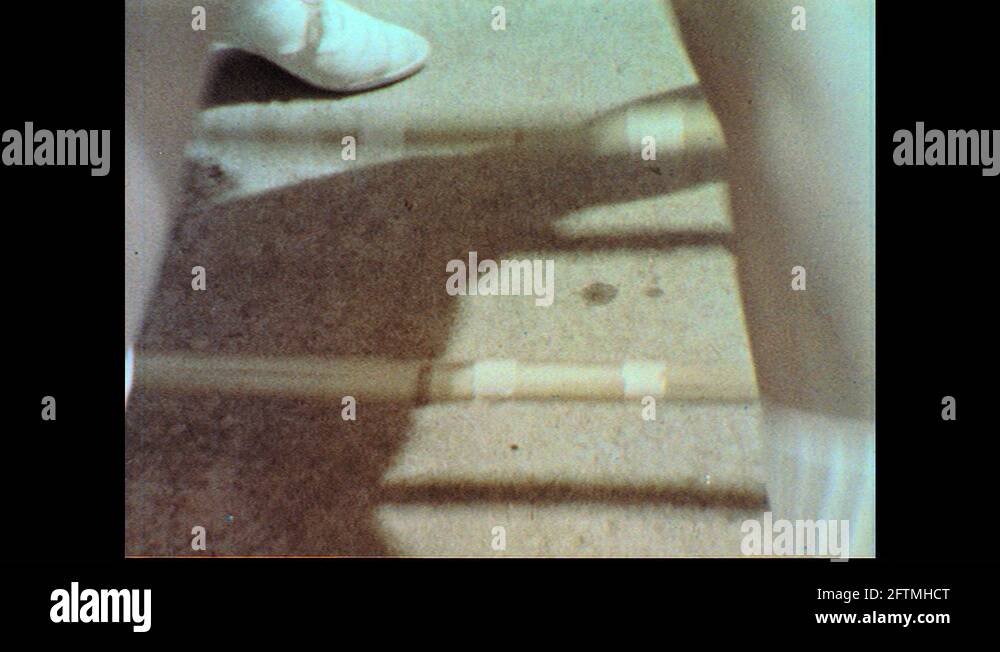 1960s: Girls sit on ground, move bamboo sticks / Girls' feet / Girls on ...