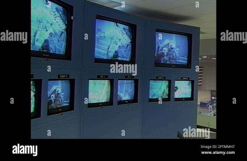 1990s: View of monitors, pan to NASA crew in control room Stock Video ...