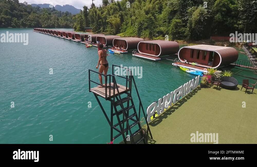 Young Girl in Bikini Jumping from Tower into Lake Water. Khao Sok ...