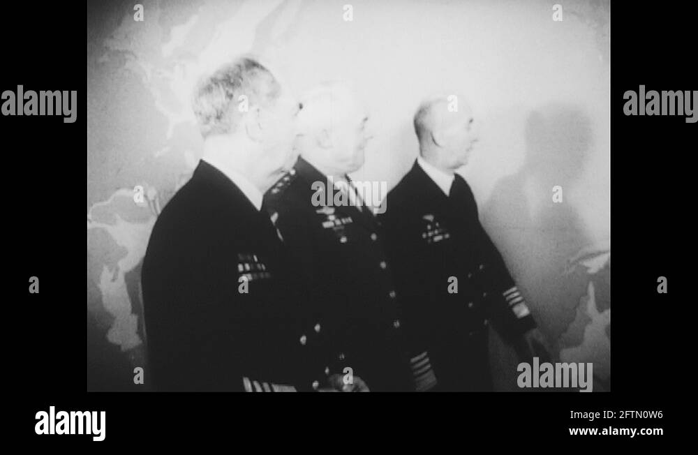 1940s: Military officers look at wall map / Close up, hand points to ...