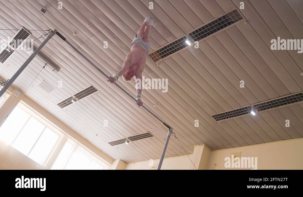 Gymnast exercises high horizontal bar HD slow-motion video. Athlete ...