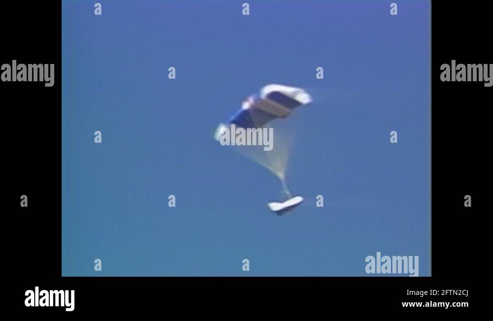 1990s: A space shuttle falls across the sky with its parachute deployed ...