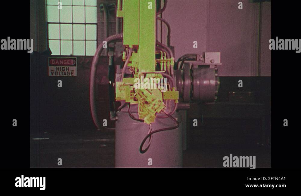 1980s: industrial robotic arm shows range of lateral motion while in ...