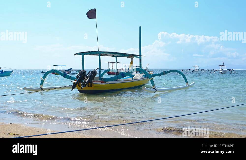 Traditional, passenger boats on popular tourist beach in Bali ...