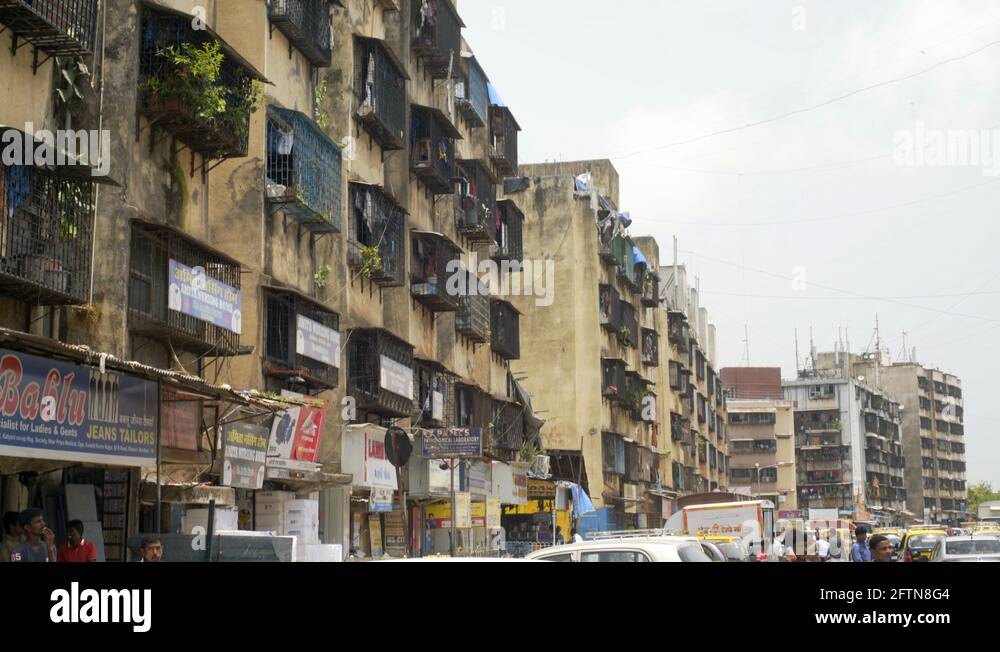 Old crumbling poor apartment buildings block, people, Mumbai slums ...