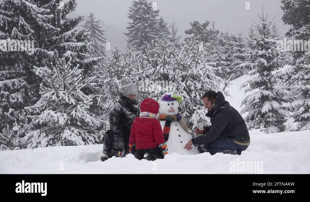 Family building snowman together in Stock Videos & Footage - HD and 4K ...