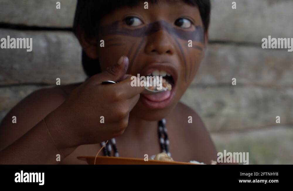Native Brazilian child eating food at Tupi Guarani Tribe Stock Video ...
