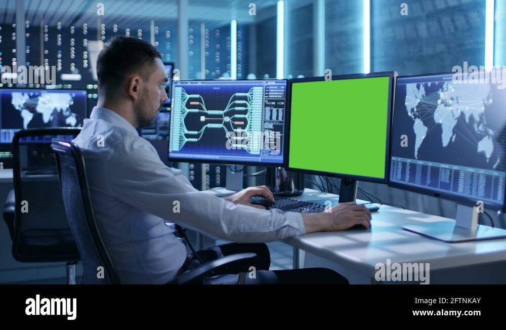 Technical Controller/ Operator Working at His Workstation with Multiple ...