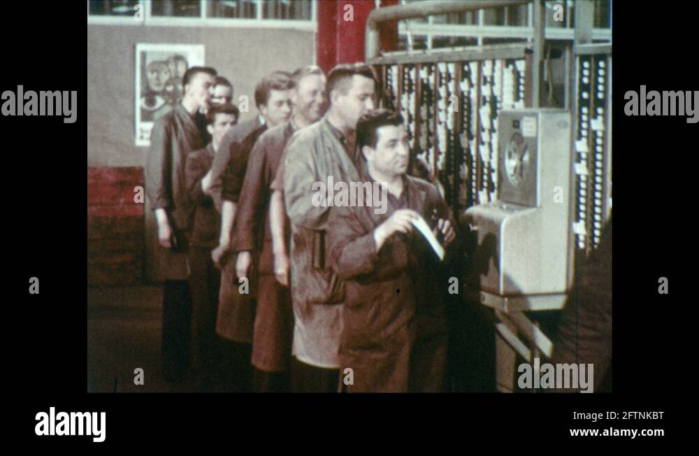 1950s: Men Clocking in for Work in Factory. Man Takes Clocking in Card ...