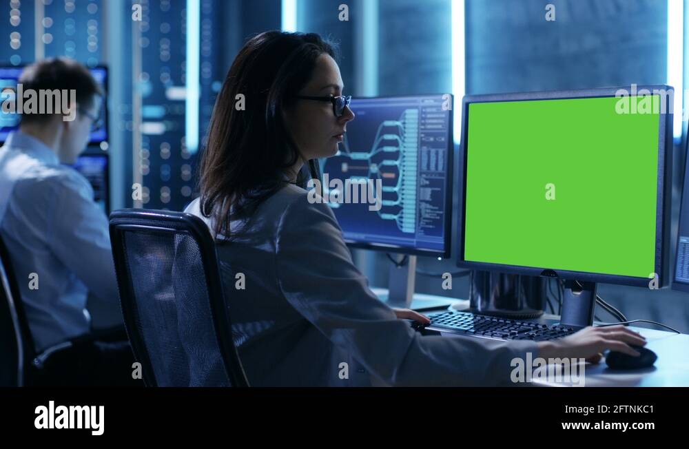 Female Controller/ Operator Working at His Workstation with Multiple ...