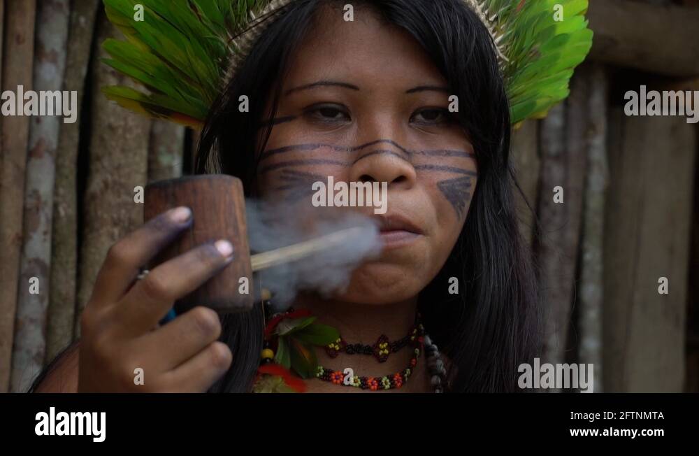 Native Brazilian woman from Tupi Guarani tribe smoking pipes, Brazil ...