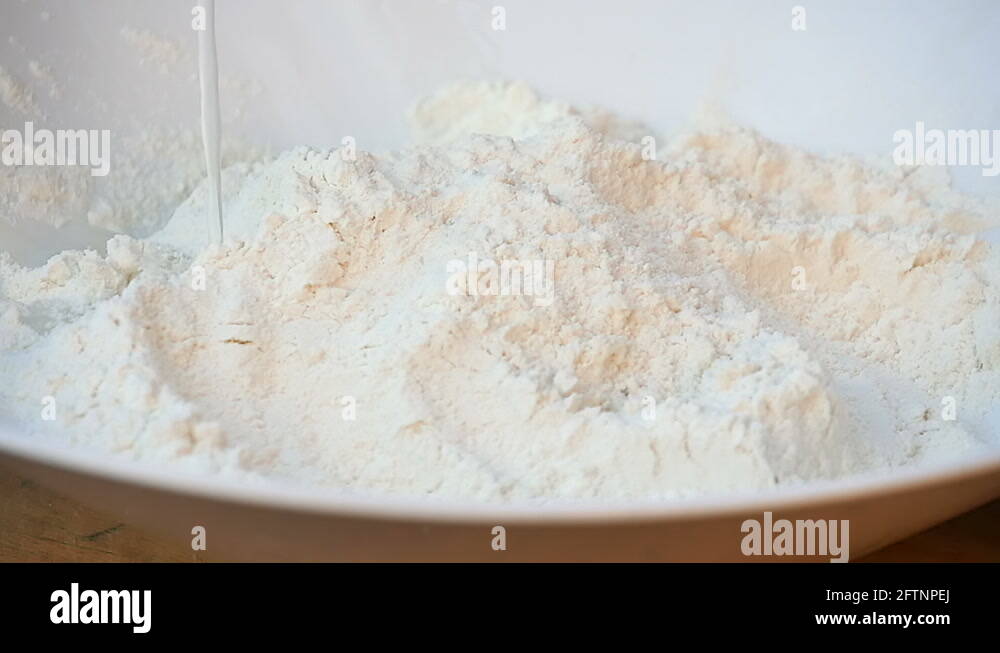 Flowing water to a palte with flour Stock Video Footage - Alamy