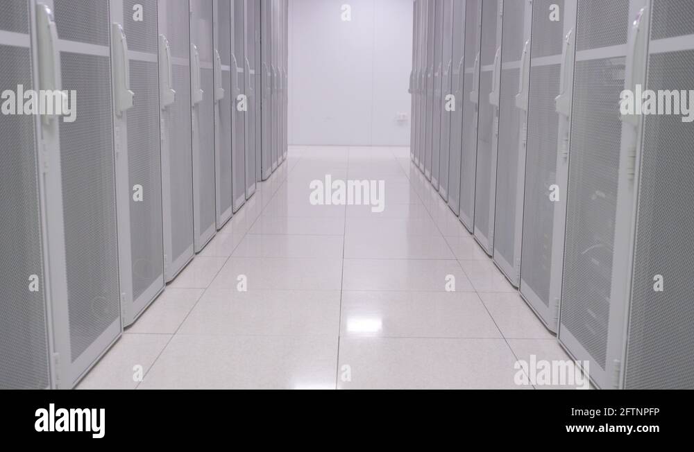 4K Empty interior of large modern data centre with rows of server racks ...