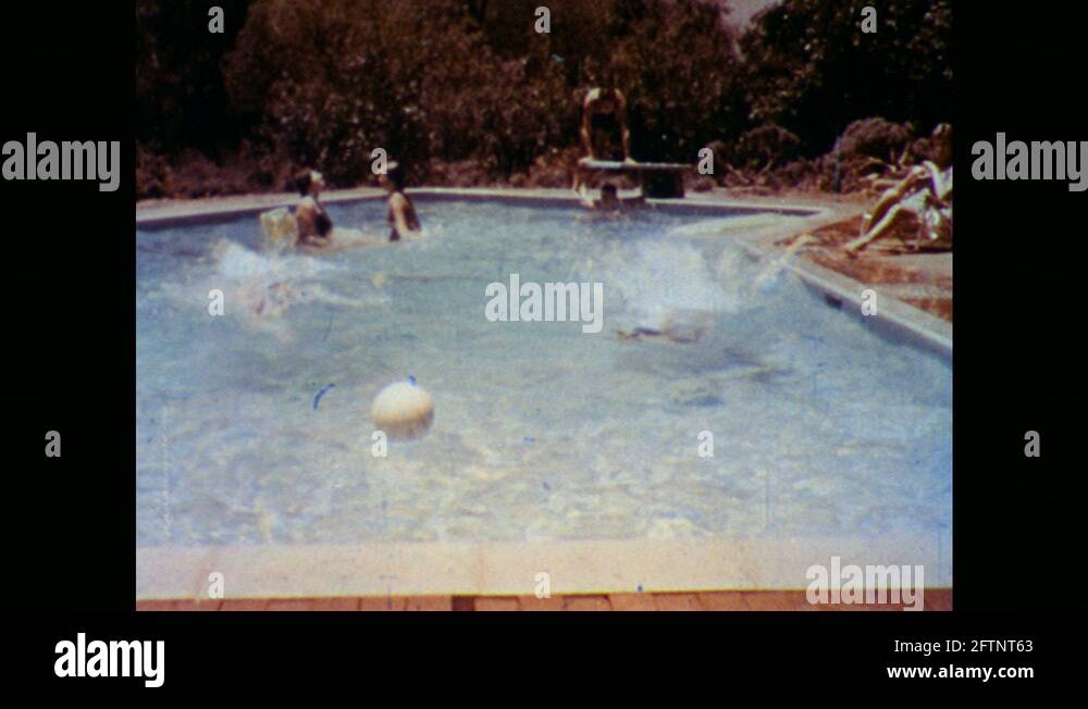 1960s: people play in swimming pool. Boy chases ball in pool. Lady in ...