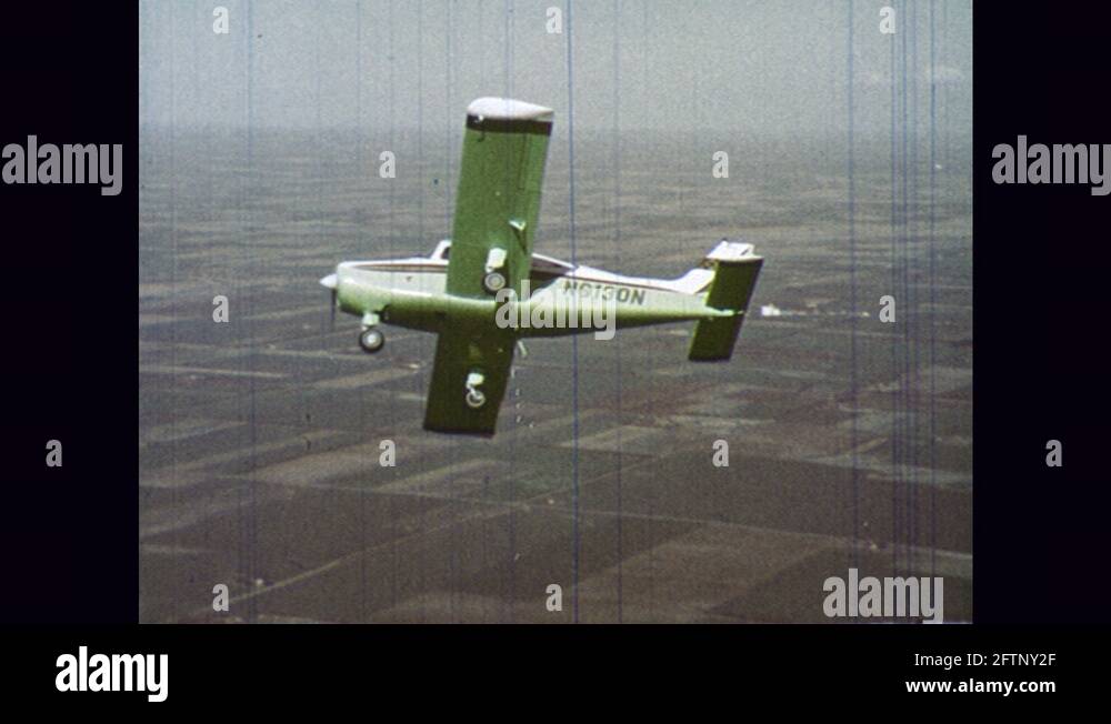 1970s: Lady turns plane in sky. Lady flies plane. Lady travels through ...