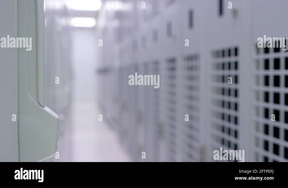 4K Empty interior of large modern data centre with rows of server racks ...
