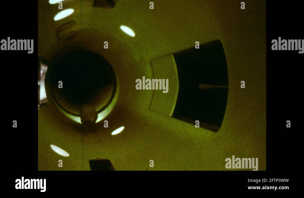 1960s: Inside chamber, panel opens / Aircraft model emerges from panel ...