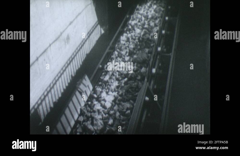 UNITED STATES, 1940s: Coke being transported along a conveyor belt ...