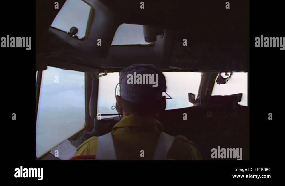 1990s: Pilot in cabin of plane. Man talks to camera. Computer monitor ...