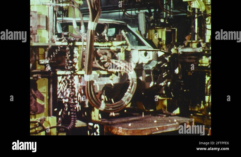 UNITED STATES: 1960s: man works on car assembly line at manufacture ...