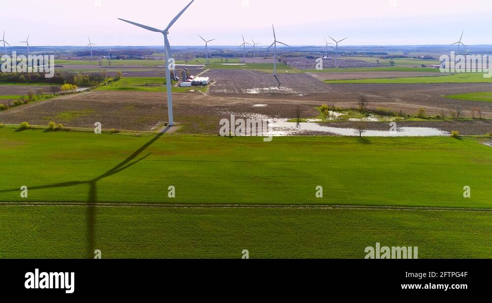 Giant wind turbines dominate the landscape, dwarfing farms and silos ...