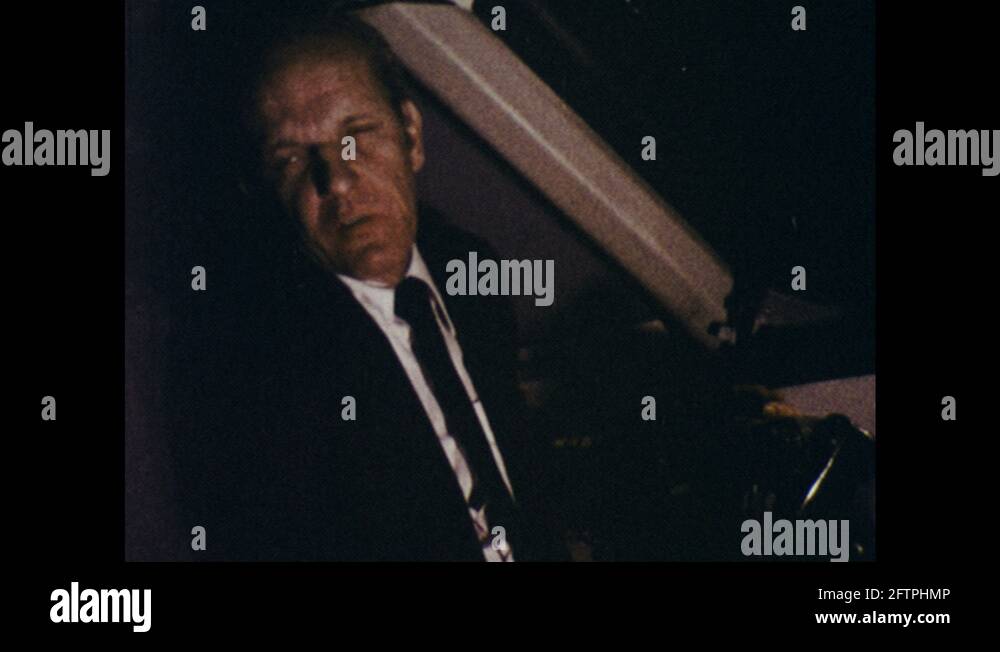 UNITED STATES 1970s: Pilot talking in cockpit / Hand on flight controls ...