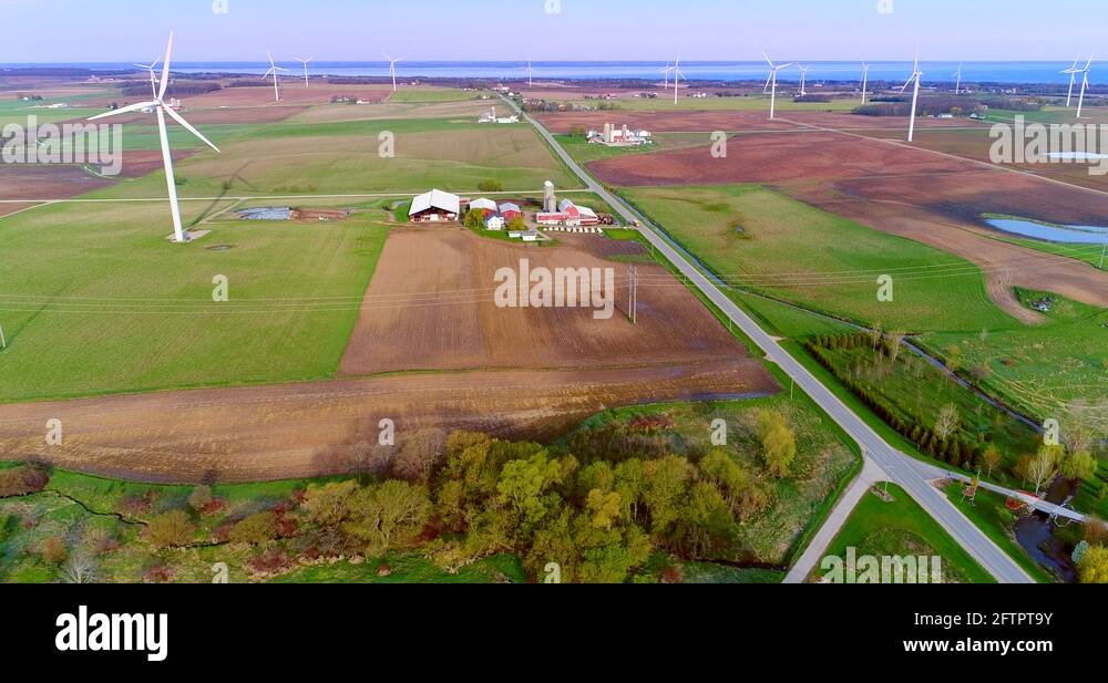 Giant wind turbines dominate the landscape, dwarfing farms and silos ...