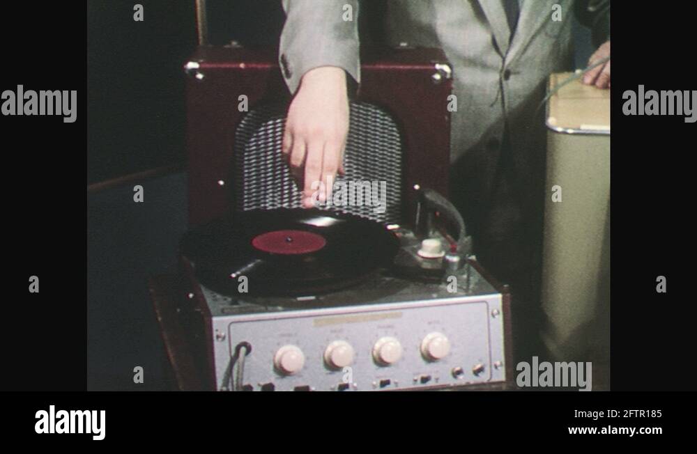 UNITED STATES: 1950s: hand points to record player. Hand points to film ...