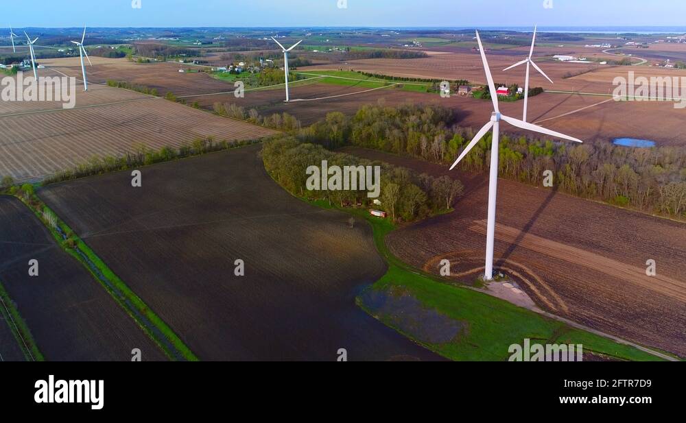 Giant wind turbines dominate the landscape, dwarfing farms and silos ...