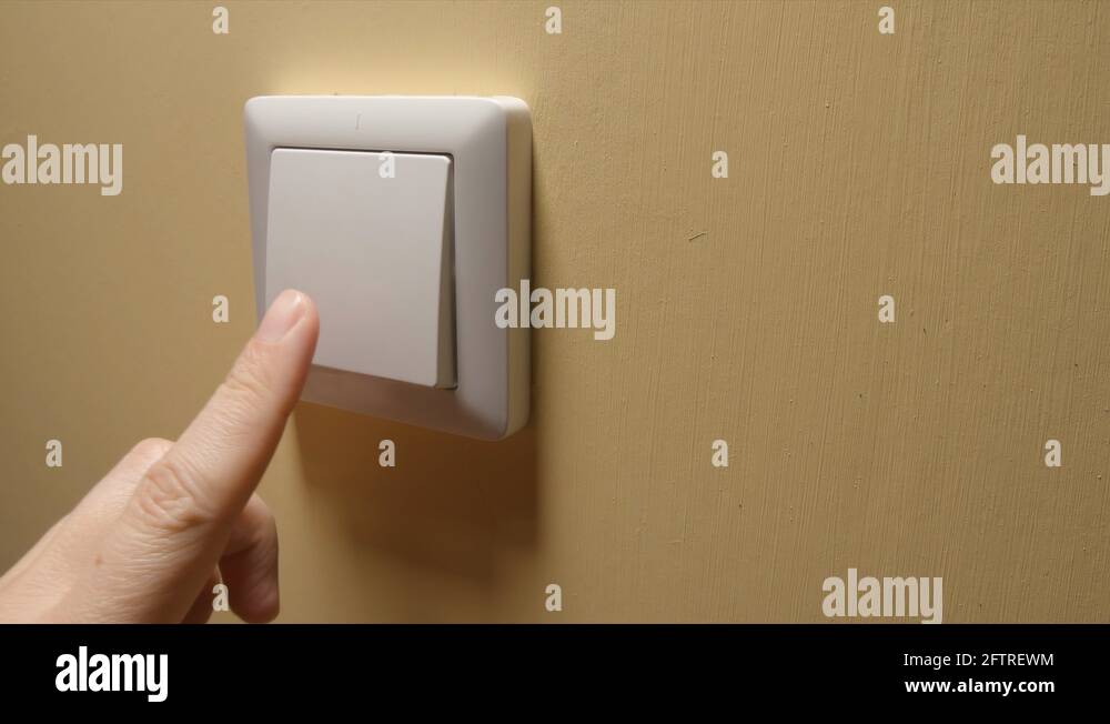 Human hand turn off a power button on a yellow wall - side view Stock ...