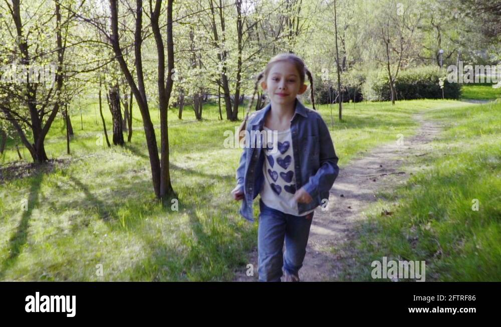 Little girl running in forest, slow motion Stock Video Footage - Alamy