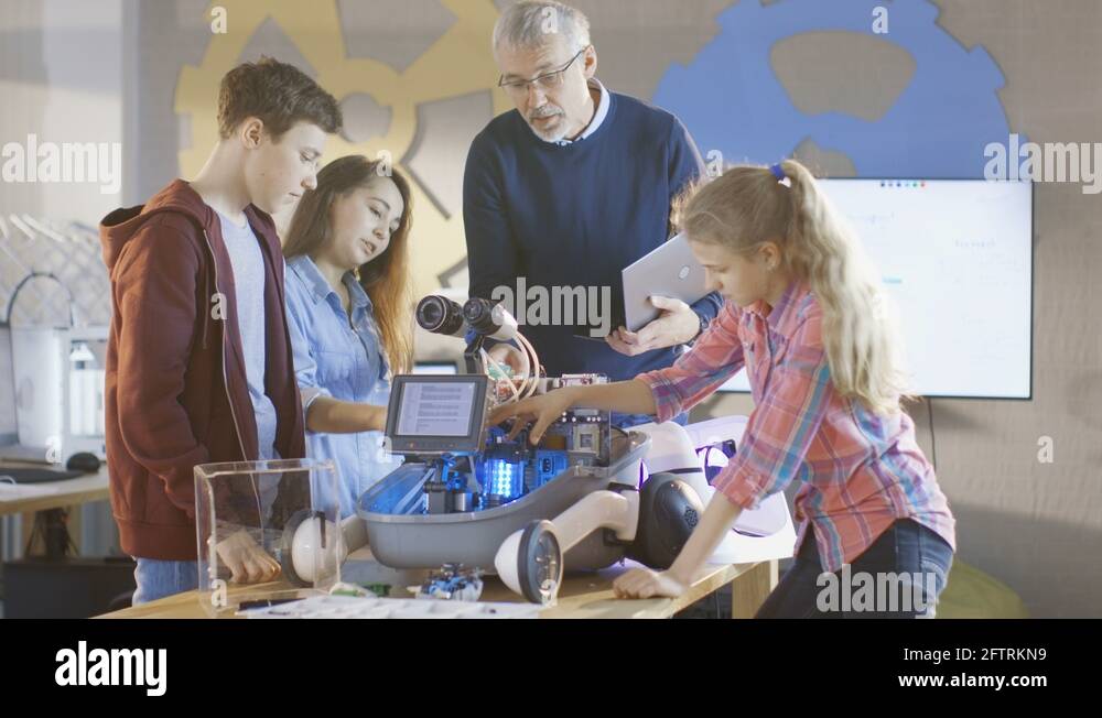 Teacher and His Pupils Work on a Programable Robot with LED ...