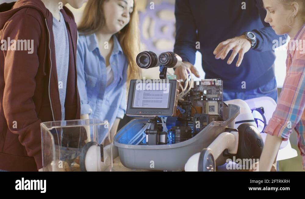 Teacher and His Pupils Work on a Programable Robot with LED Lights ...