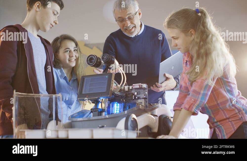 Teacher and His Pupils Work on a Programable Robot with LED ...