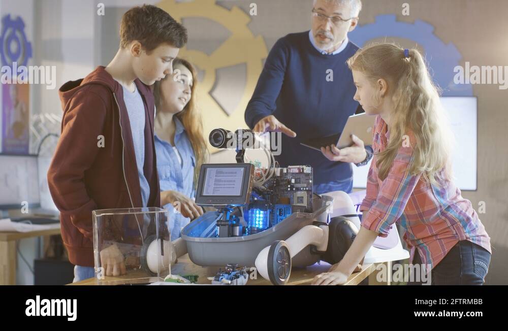 Teacher and His Pupils Work on a Programable Robot with LED Lights ...