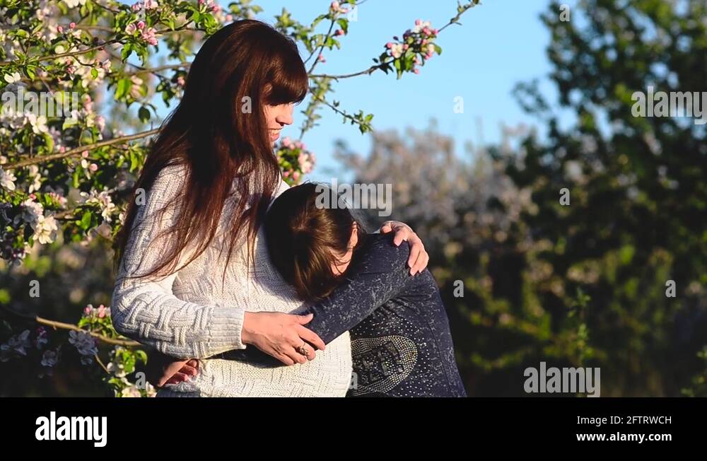 Daughter hugs belly of pregnant mother. Pregnant mother hugging ...