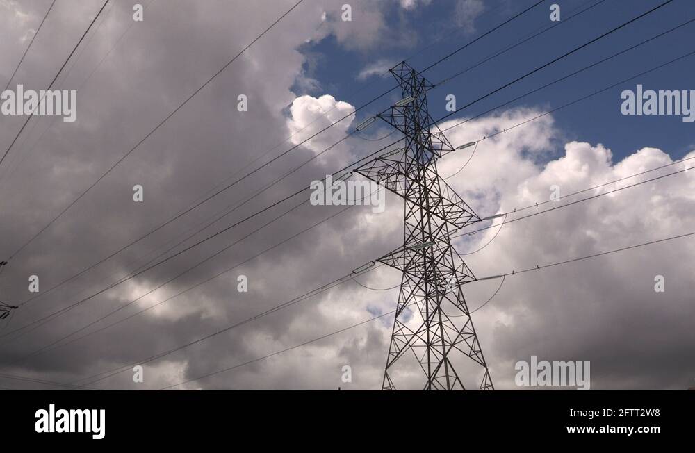 Electricity grid power lines and transmission towers with cumulus ...