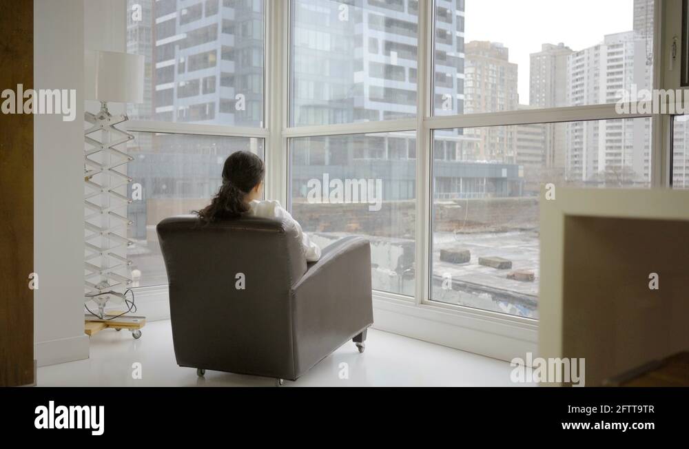 Woman in her 30s inside a modern condominium in downtown toronto ...