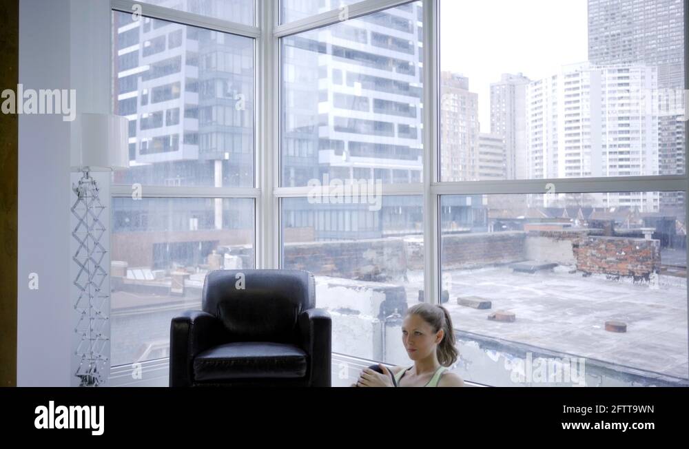 Woman in her 30s inside a modern condominium in downtown toronto ...