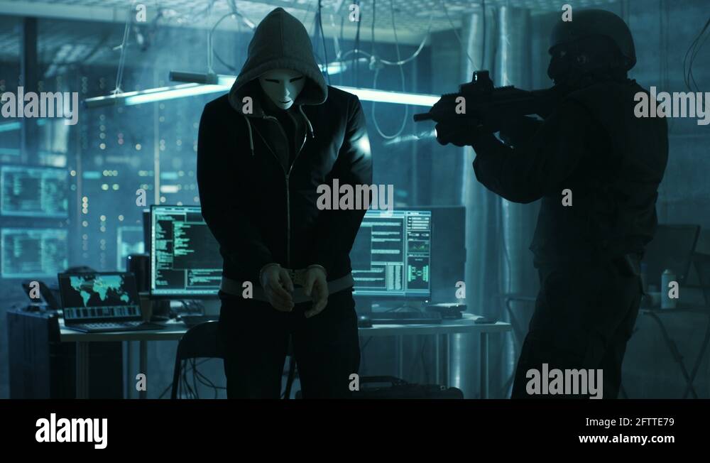 Masked Hacker Wearing Handcuffs is Guarded by Fully Armed Special ...