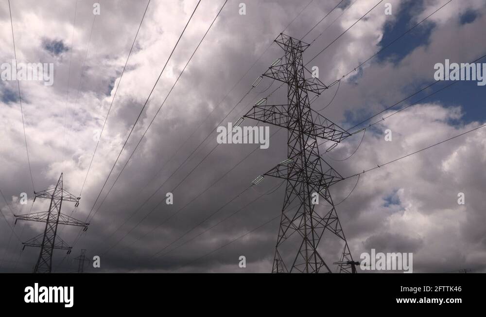 Electricity grid power lines and transmission towers with cumulus ...
