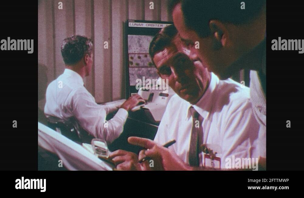 1960s: Men at drafting table. Man at drafting table. Man inspects photo ...