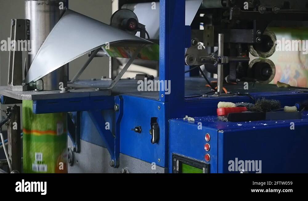 Packaging machine at workshop of food factory Process of packaging ...