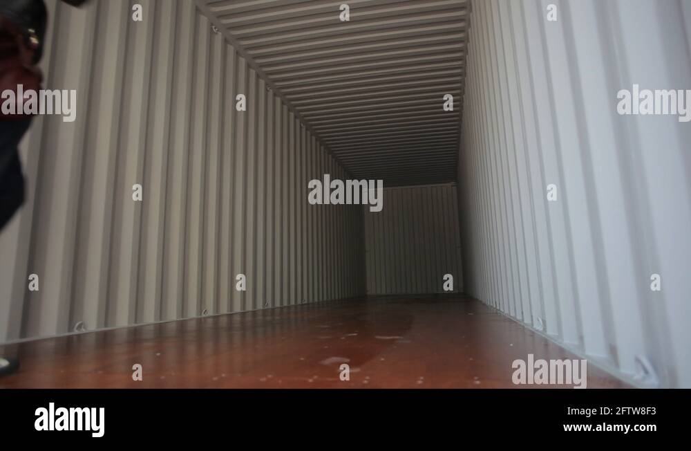 Inside an empty shipping container. Man is checking a container Stock ...