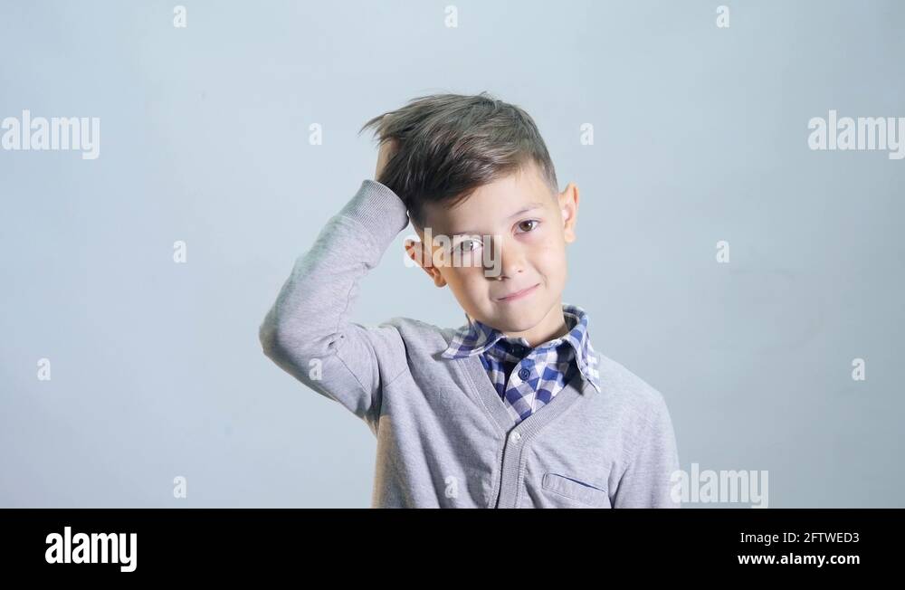 The boy scratches his hair and thinks up Stock Video Footage - Alamy