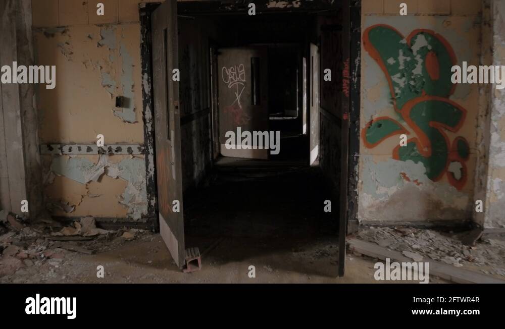 FPV Passing through dark spooky narrow hallway following weathered ...