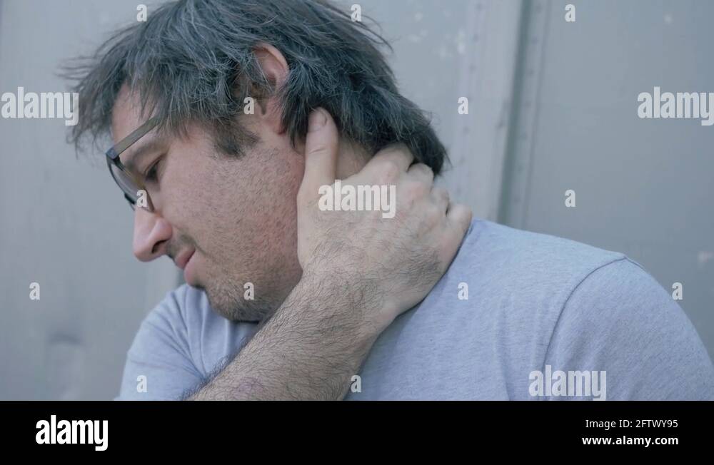 Man rubbing his neck Stock Videos & Footage - HD and 4K Video Clips - Alamy