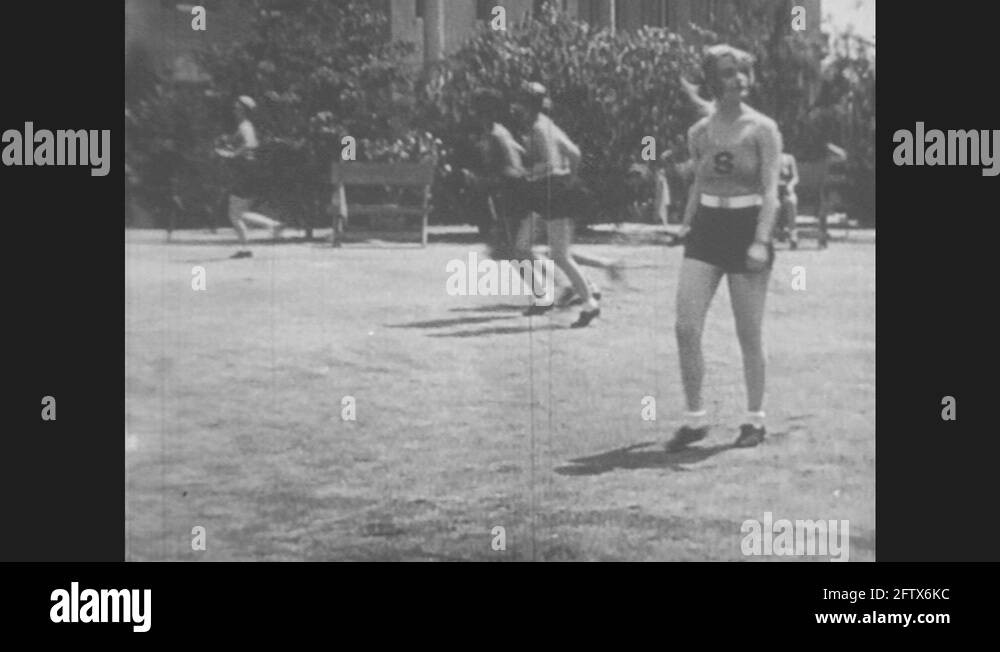 1920s: woman in gym outfit powders her nose on outdoor field. woman in ...